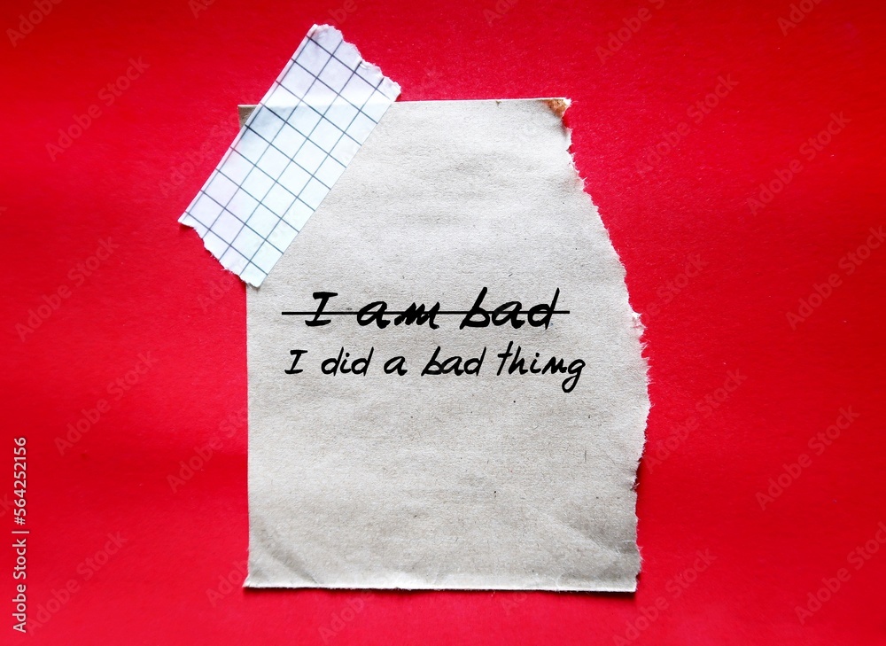 Torn stick note on red background with handwritten text I AM BAD ...