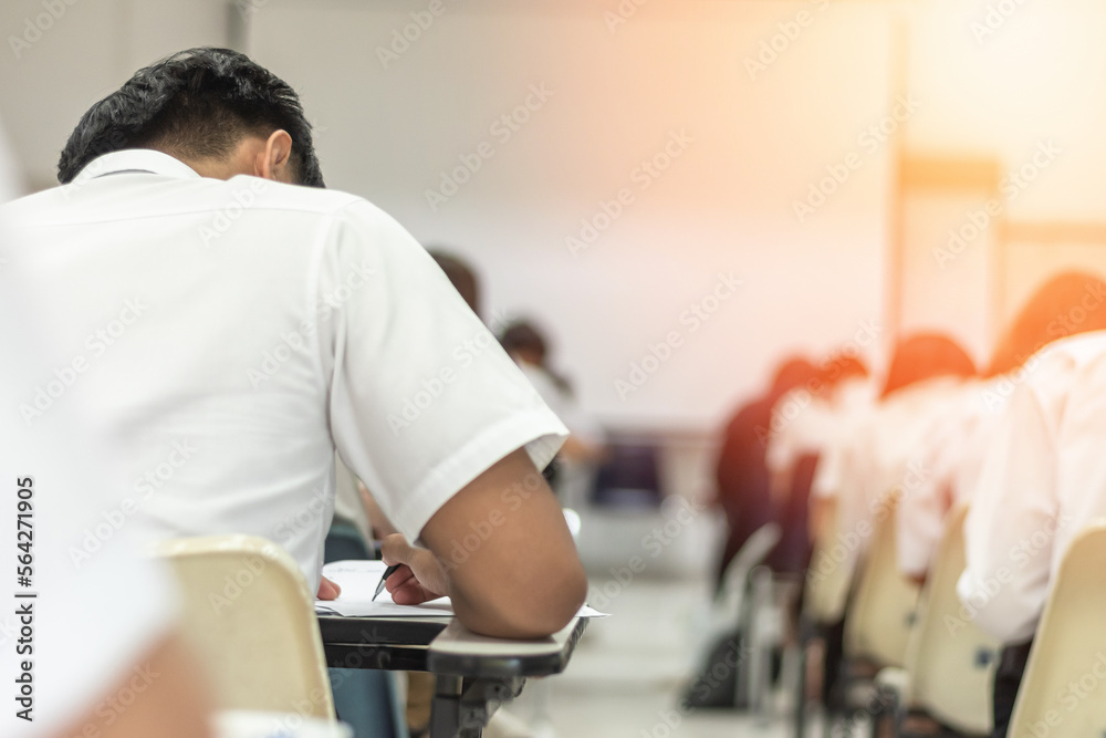 School student exam in university class with blurry view from back of ...