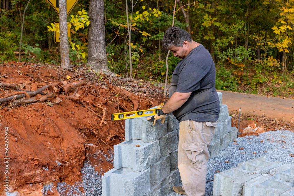 An contractor was installing concrete block after leveling walls on ...