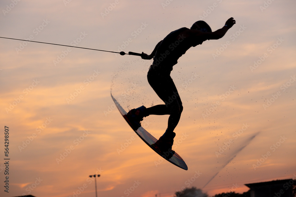 Silhouette Wakeboarder making tricks on sunset, Young surfer ...