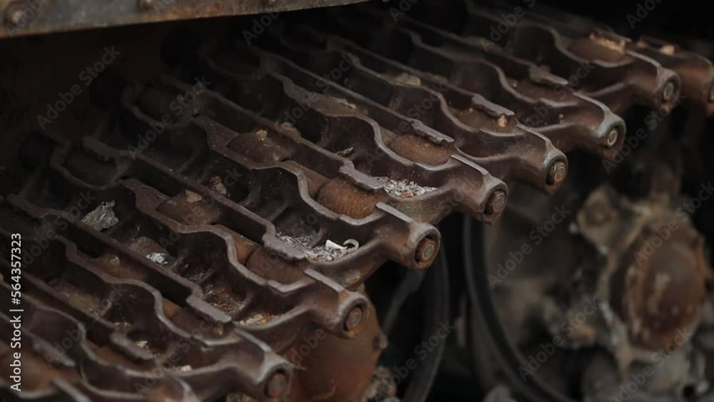 caterpillars of a burned-out Russian tank. Side view of a tank track on ...