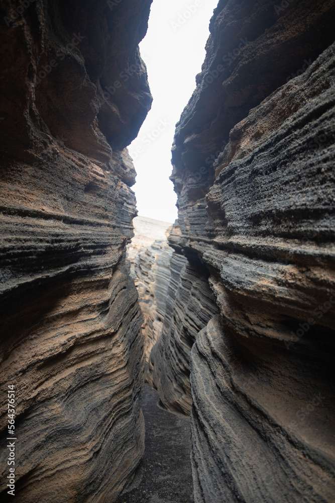 Natural corridor made by vertical rocks with texture of horizontal ...