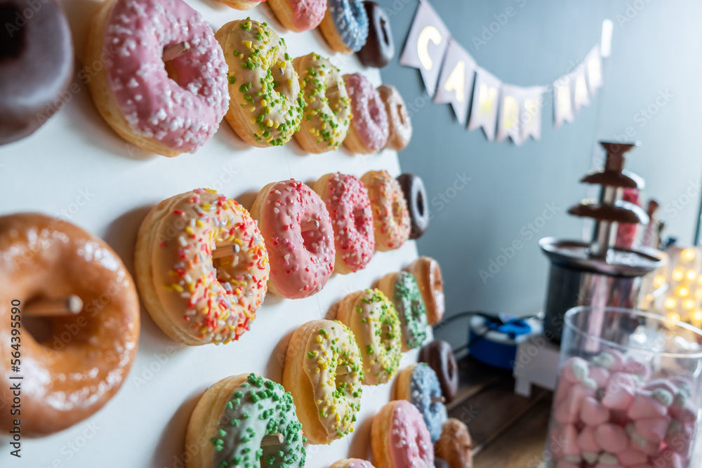 Foto de Candy bar with donuts. Table with different sweets for party ...