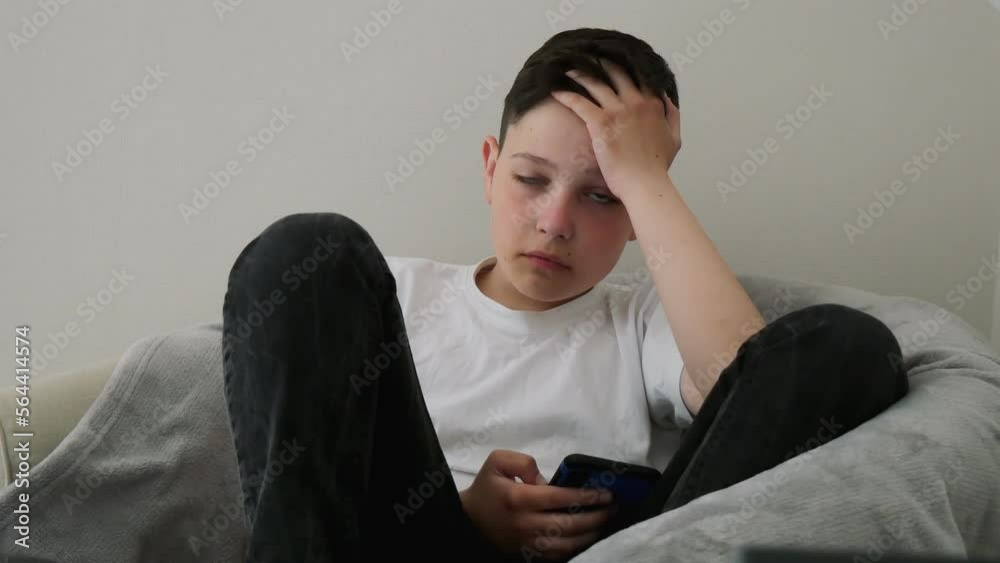 boy, teenager sits and is sad, cries. Teenage depression. Stock Video ...