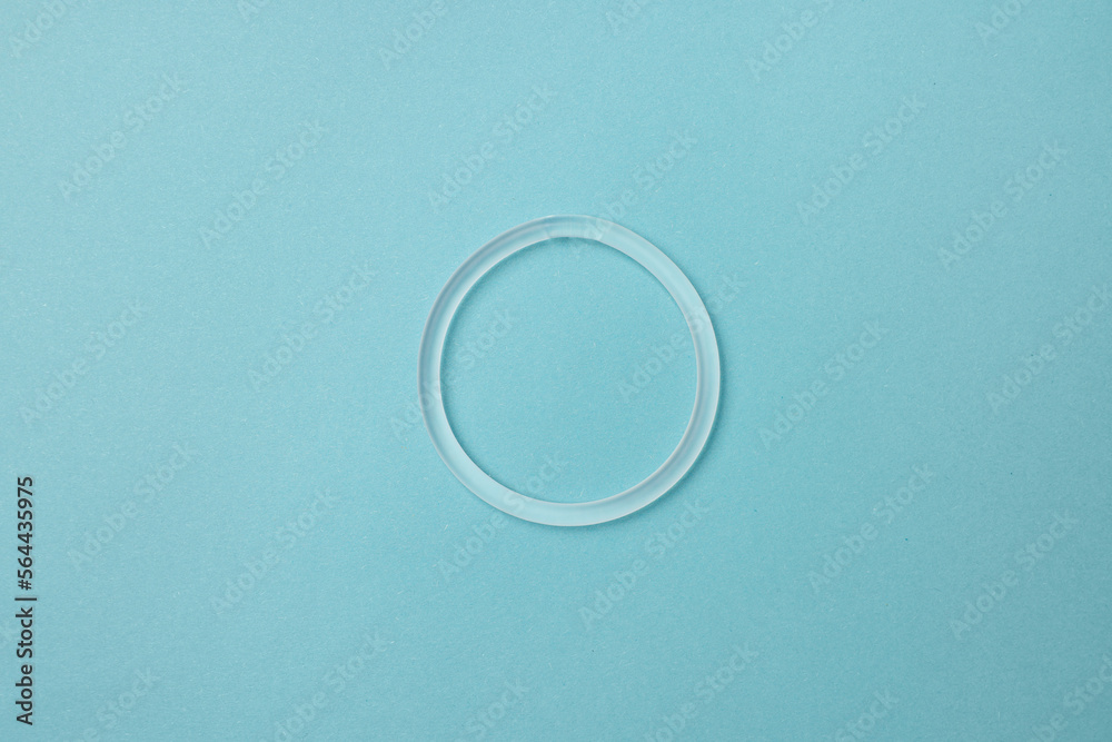 Diaphragm vaginal contraceptive ring on light blue background, top view ...
