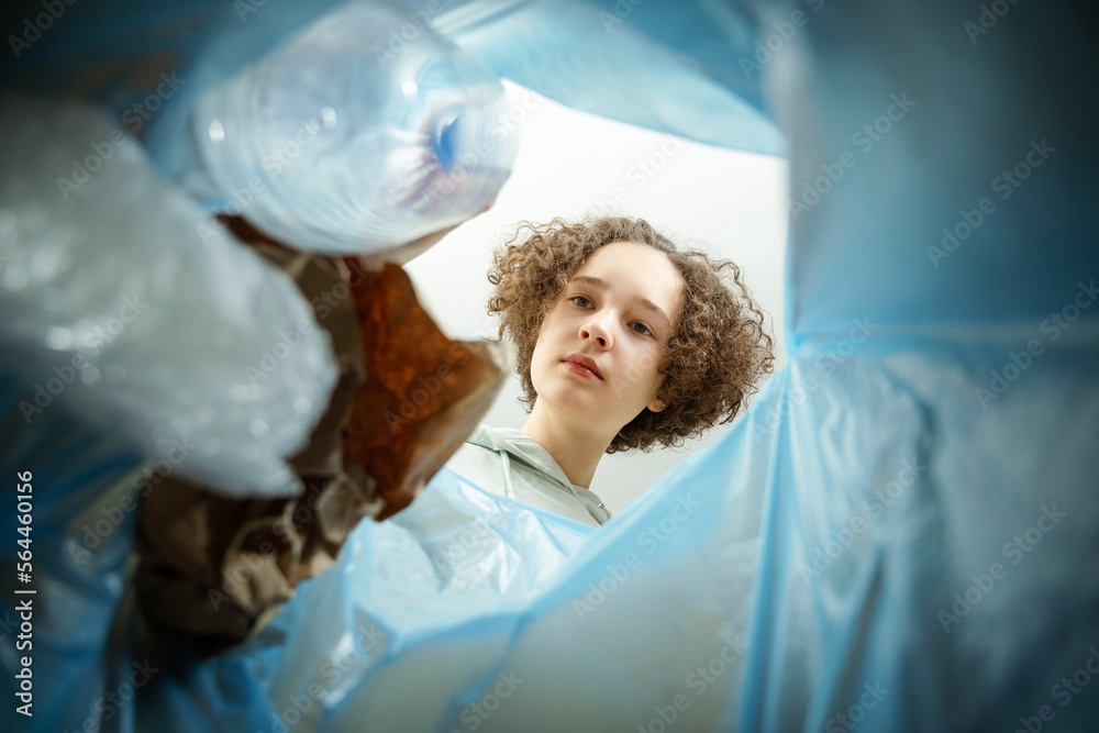 Female puts plastic bottle in trash can, view from the inside Garbage ...