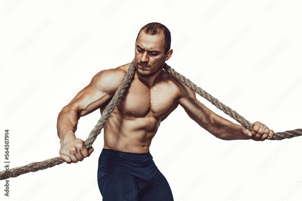 Strong young muscular man holds rope hanging on neck and shoulders ...