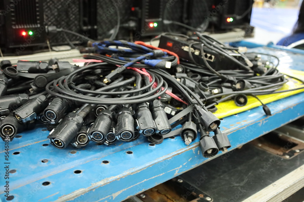 Power cable for LED screen. Close-up of many cable stacks of table top ...