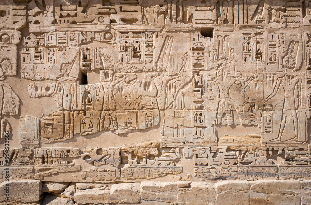 Sandstone wall with images of ancient Egyptian symbols, hieroglyphs ...