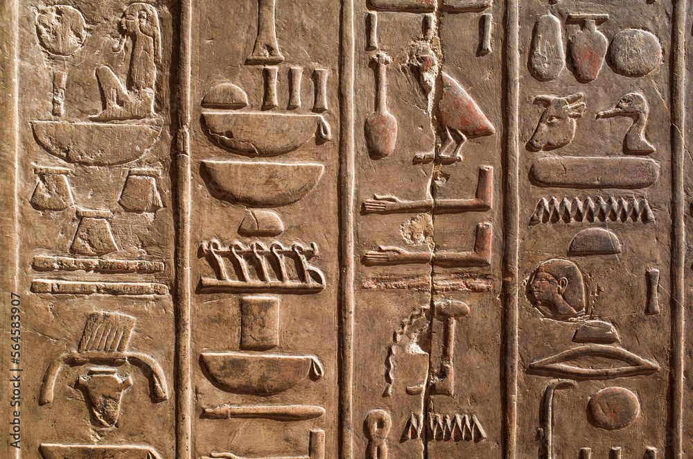 Close-up ancient Egyptian hieroglyphs inscription on the wall of the ...