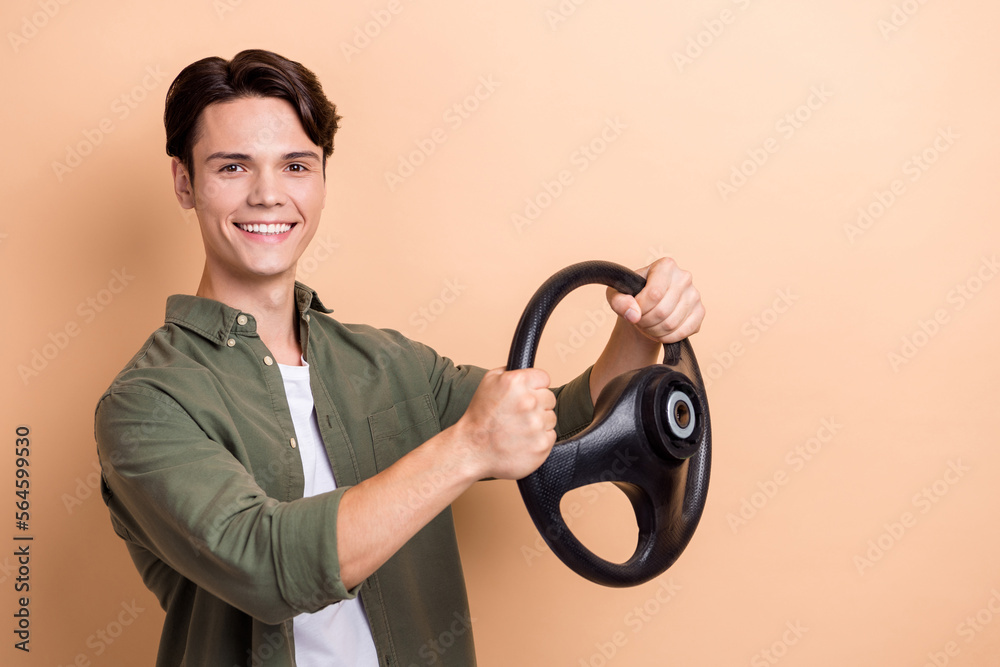 Photo of young guy learning new way driving steering wheel test ...