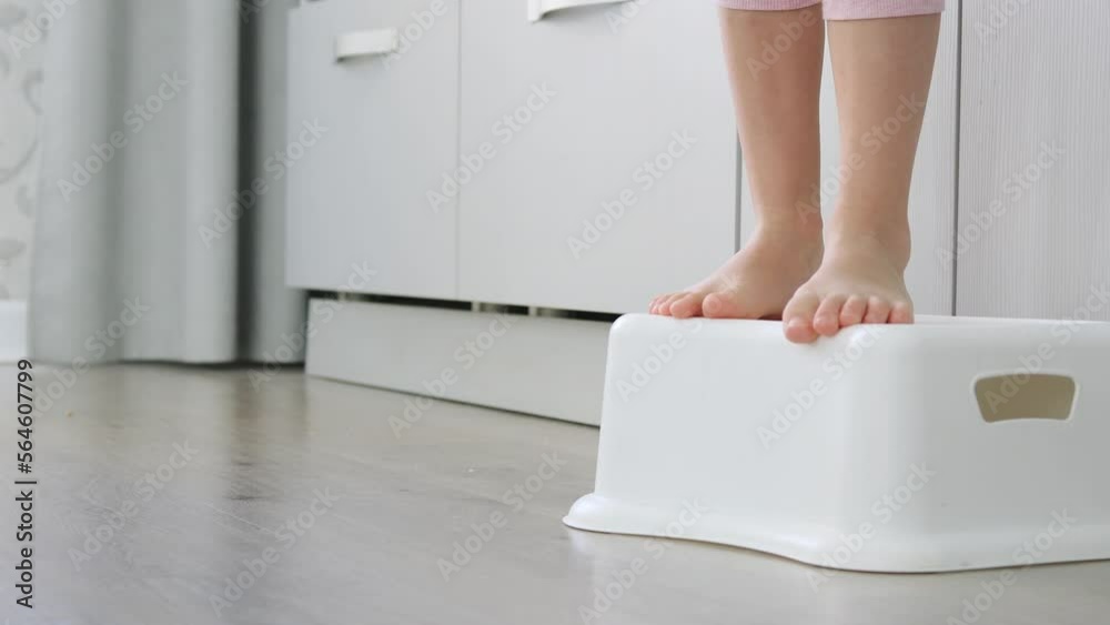 Small children's legs getting up on the step. Small children's legs ...