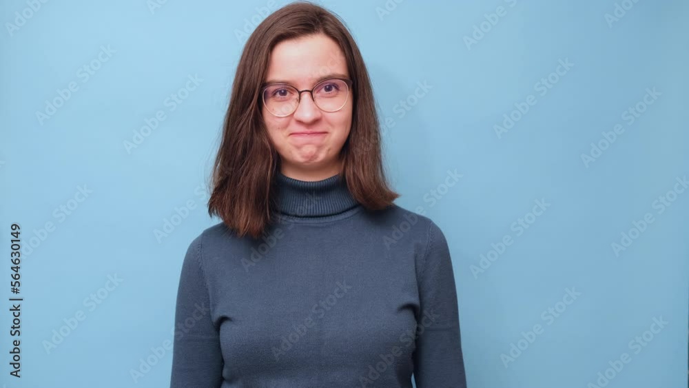 A smug smile. Portrait of a female student in glasses and a sweater ...
