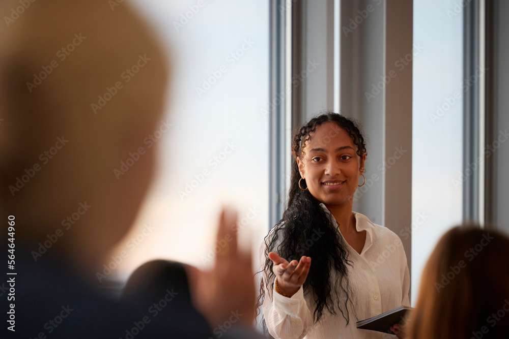 Smiling speaker answering questions during business seminar Stock Photo ...