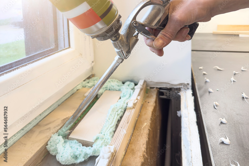 The process of installing a window sill. The master applies mounting ...