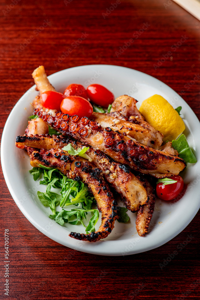 Grilled octopus. Prepared in traditional Italian style: fried in olive ...