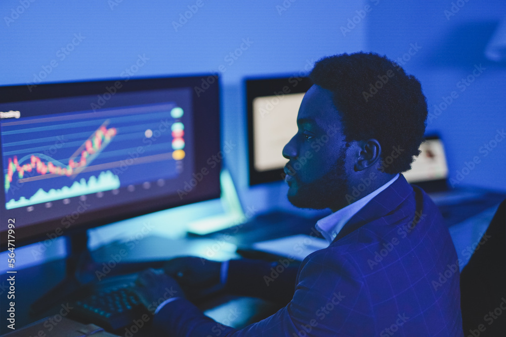 Trader african business man working inside office at night time Stock ...