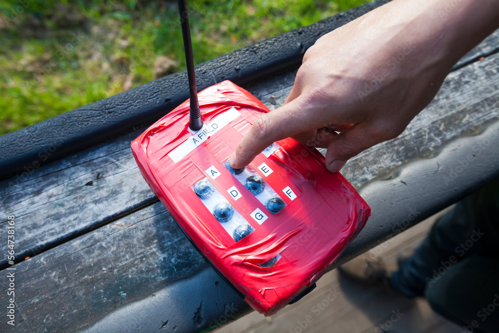 Shooter using remote control to fire clay pigeon at shooting range ...