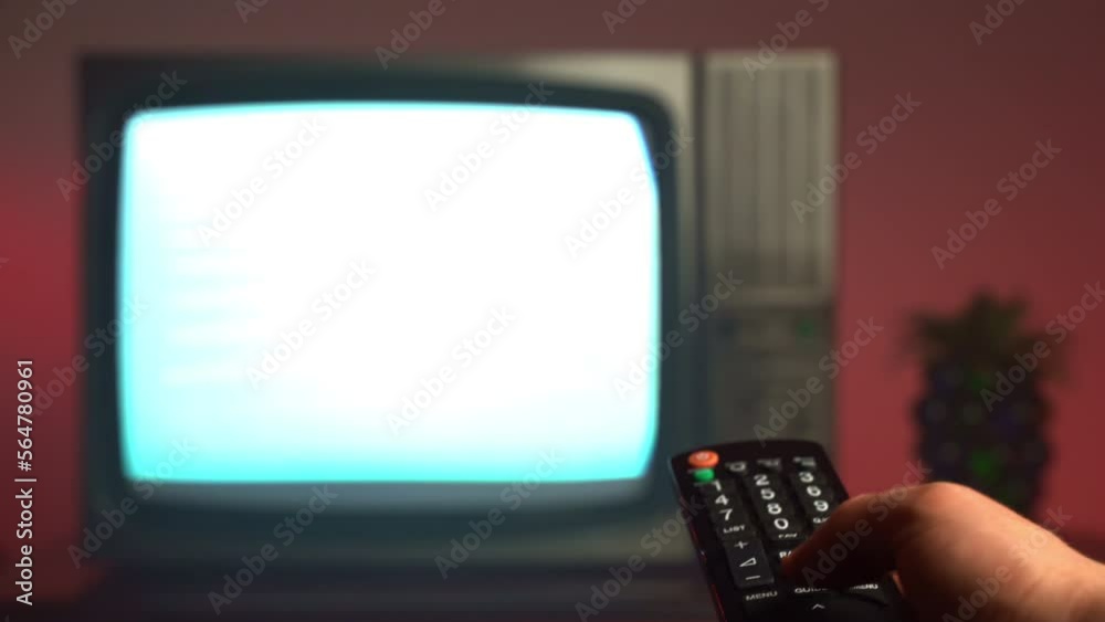 Old vintage TV on red background, person changing channels with remote ...
