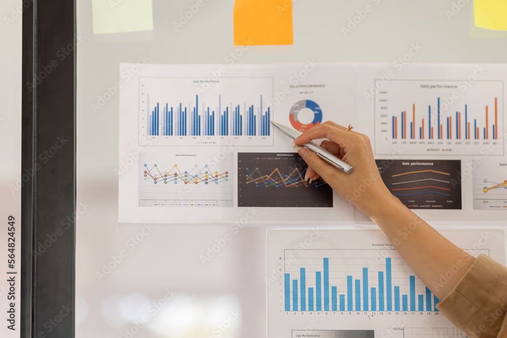 young asian entrepreneur of small company putting a adhesive sticky ...