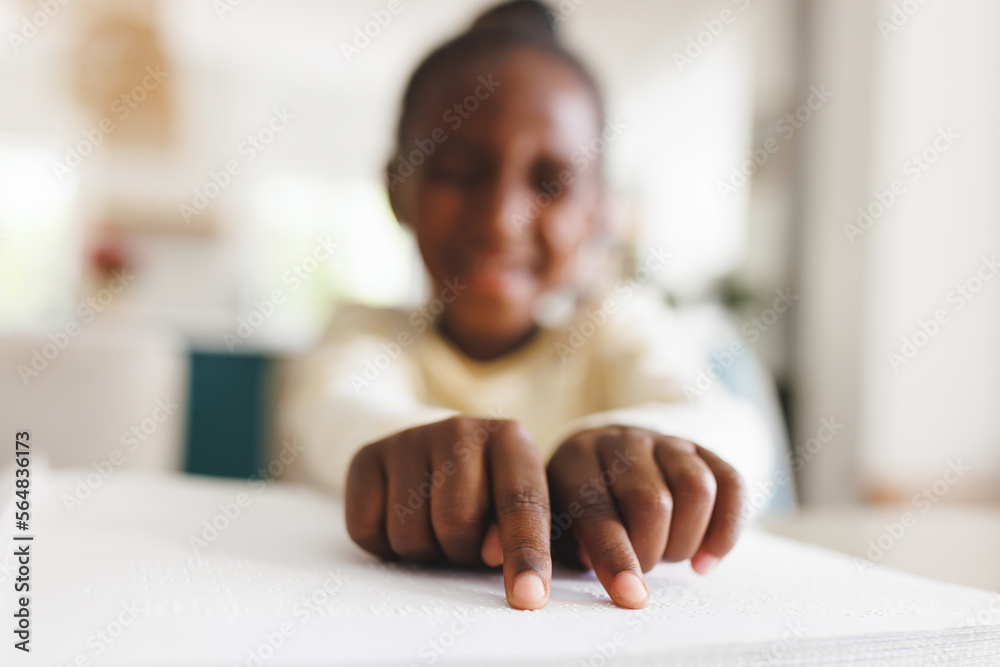 Blind african american girl reading braille Stock Photo | Adobe Stock