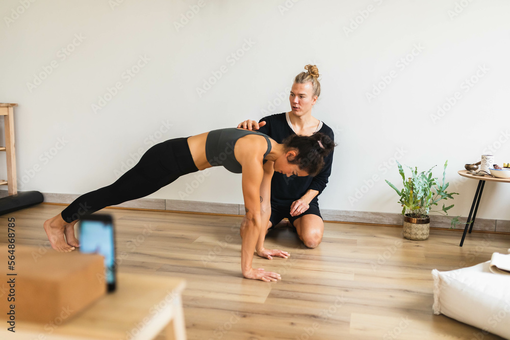 Instructor helping student with exercise technique Stock Photo | Adobe ...