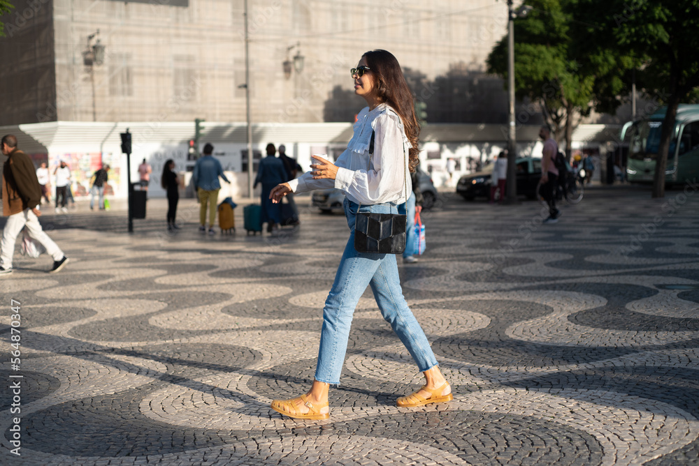 Beautiful woman walking in the street candid portrait Stock Photo ...