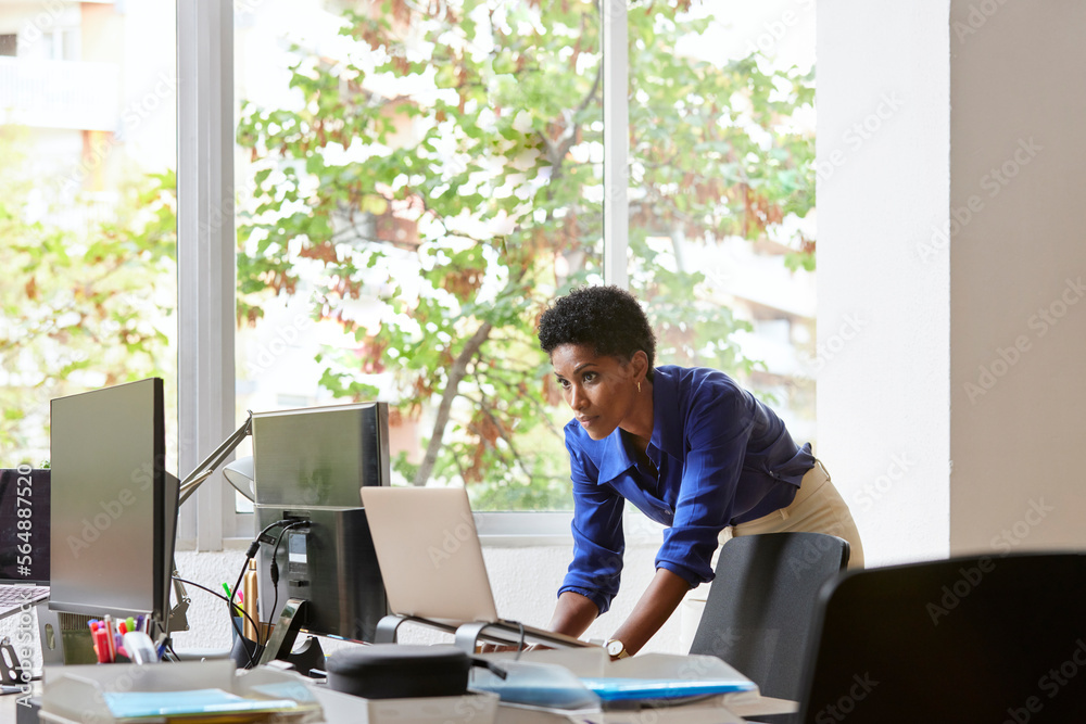 Black manager checking connection of computers Stock Photo | Adobe Stock