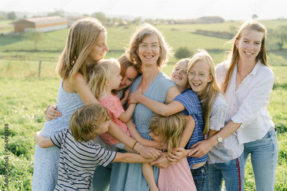 mother and her eight children hugging Stock Photo | Adobe Stock