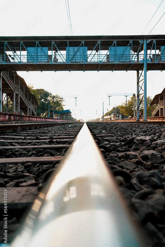 Low angle shot railway track with RAILWAY STEEL FOOT OVER BRIDGE ...