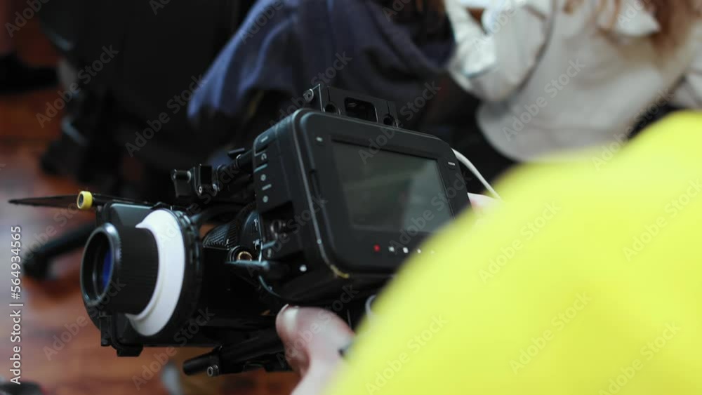 Cameraman operator holds digital cinema camera in hands, backstage ...