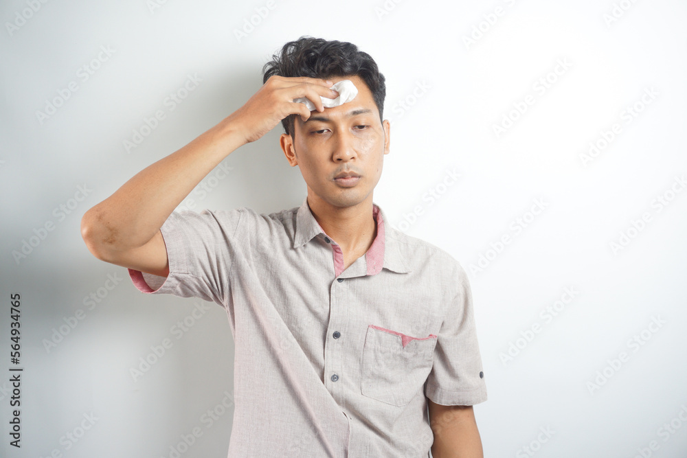 Isolated on white studio background overheated sweaty young man ...
