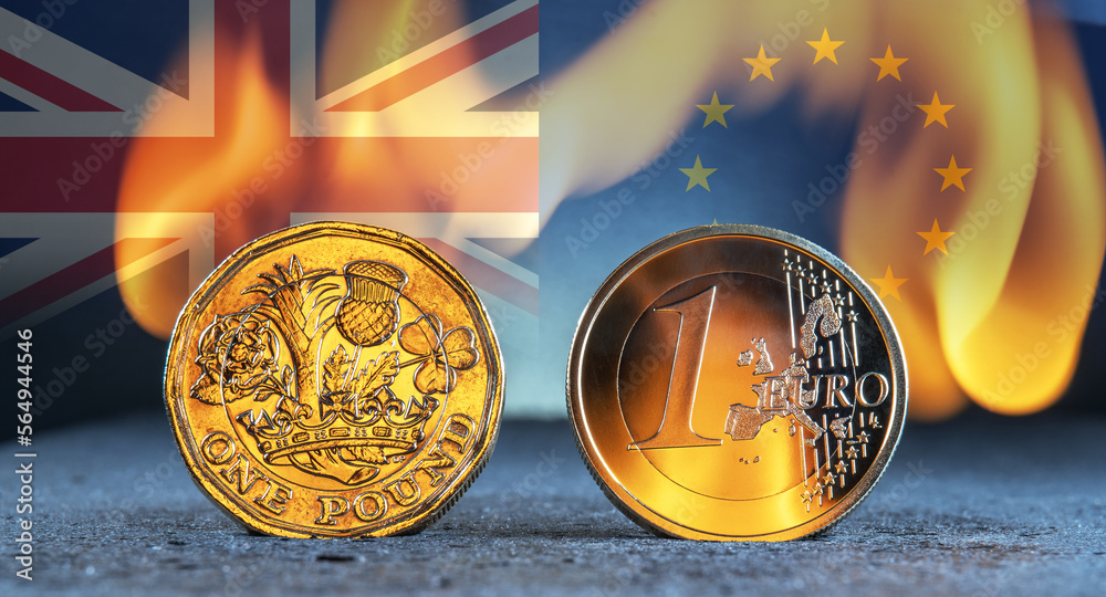 One pound coin with one ounce coin standing side by side in front of ...