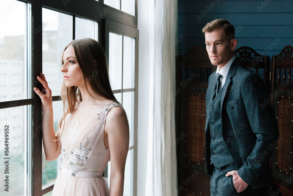 Beautiful stylish and fashionable couple in a suit, dress and coat with ...