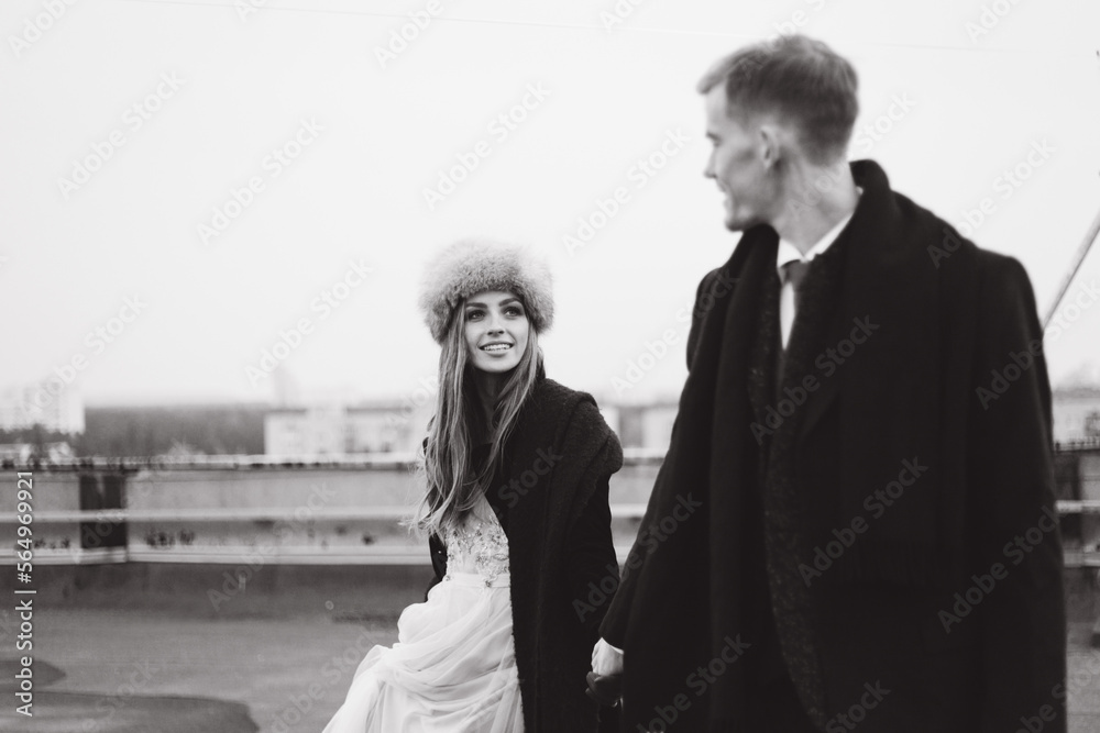 Beautiful stylish and fashionable couple in a suit, dress and coat with ...