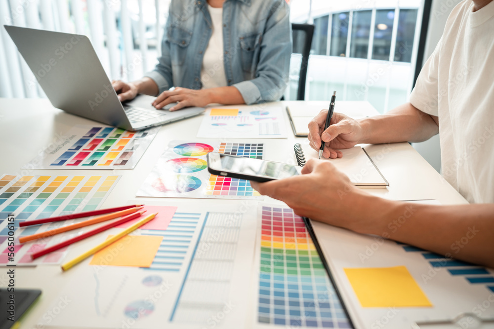 Two creative graphic designer team working on color selection and ...