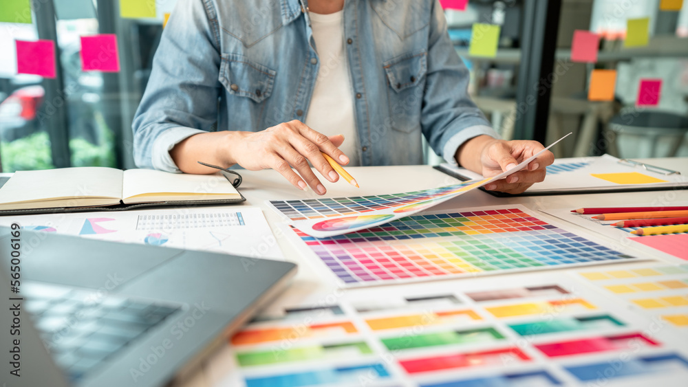 Young creative graphic designer working on color selection and drawing ...