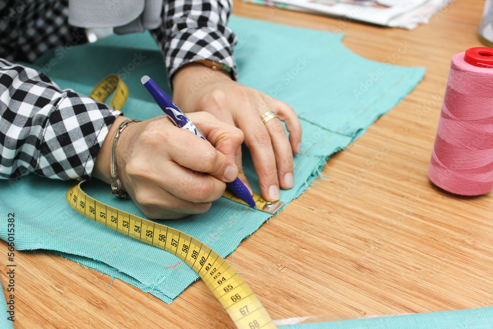Tailor woman sewing beautiful dress Stock Photo | Adobe Stock