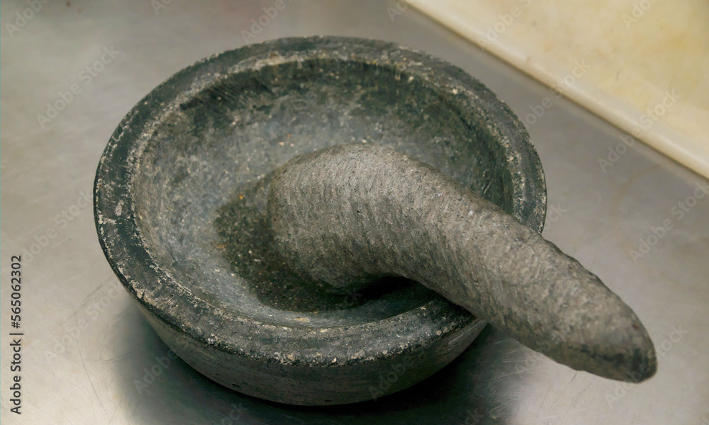 Indonesian traditional kitchenware named "cobek and ulekan" i.e. stone ...