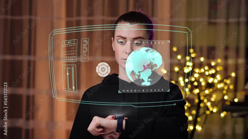 A young girl checks her vital data on a smartwatch with a hologram ...