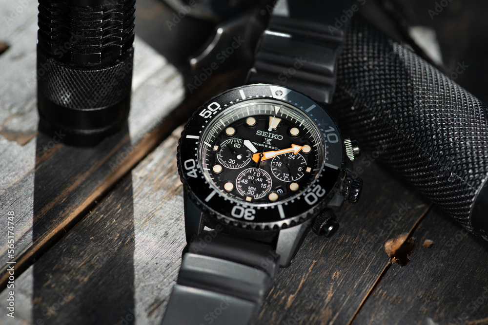 SEIKO Prospex black diver watch and knife no wooden table. Black ...