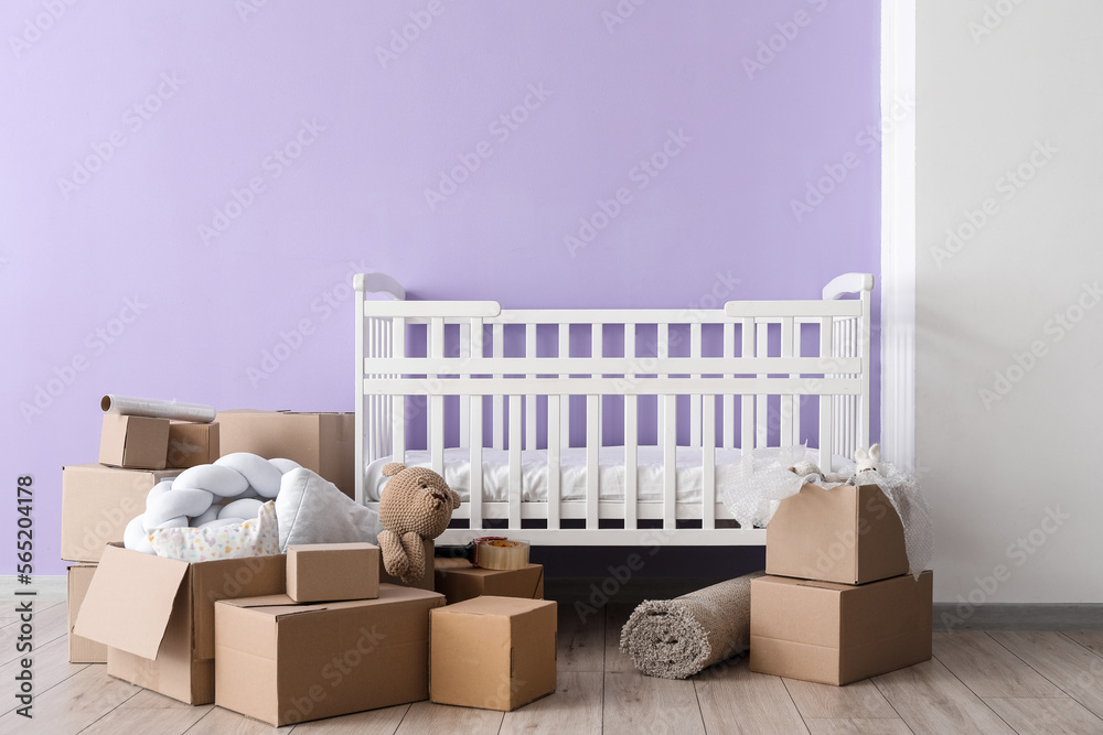 Cardboard boxes with baby crib in children's bedroom on moving day ...