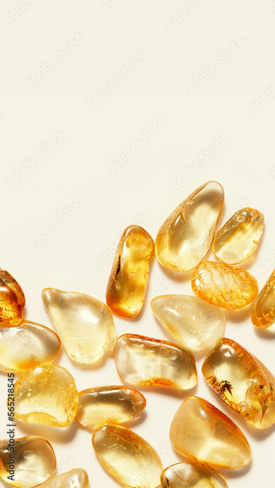 Amber stones on beige background, transparent stone yellow beige color ...