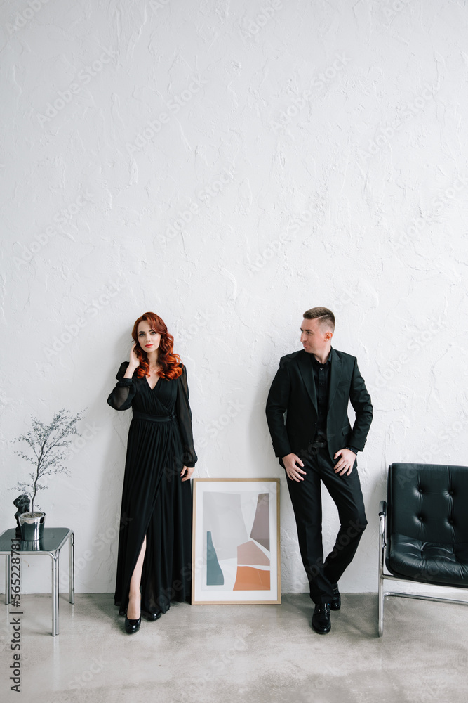 Stylish beautiful photo session in a photo studio of a luxurious couple ...