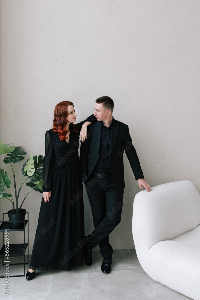 Stylish beautiful photo session in a photo studio of a luxurious couple ...