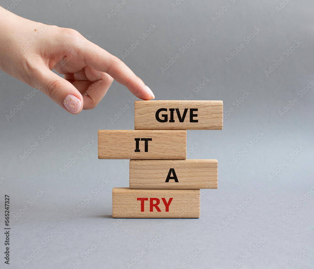 Give it a try symbol. Concept words Give it a try on wooden blocks. Beautiful grey background ...