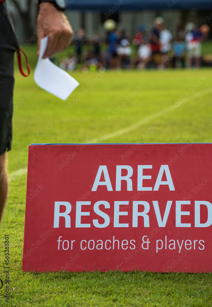 Area reserved banner sign on the sideline of a football pitch in a ...