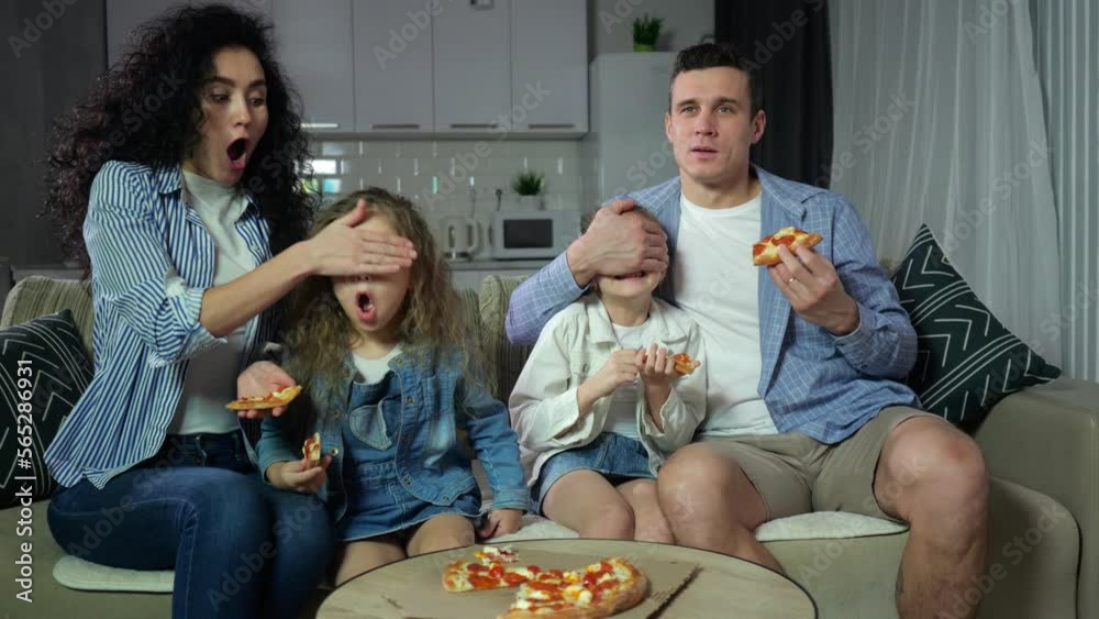 Family watches horror movie together and eats yummy pizza at home ...