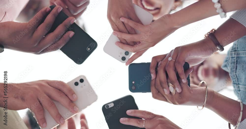 Hands, phone and communication with friends standing in a huddle or ...