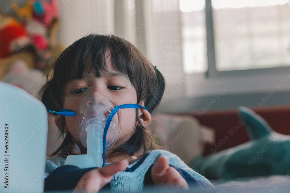 Girl using Oxygen breathing machine at home smile and surprice ...